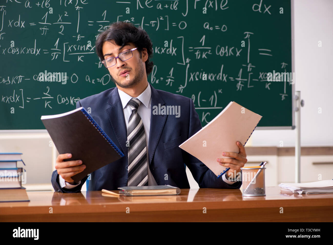 Young male math teacher in classroom Stock Photo - Alamy