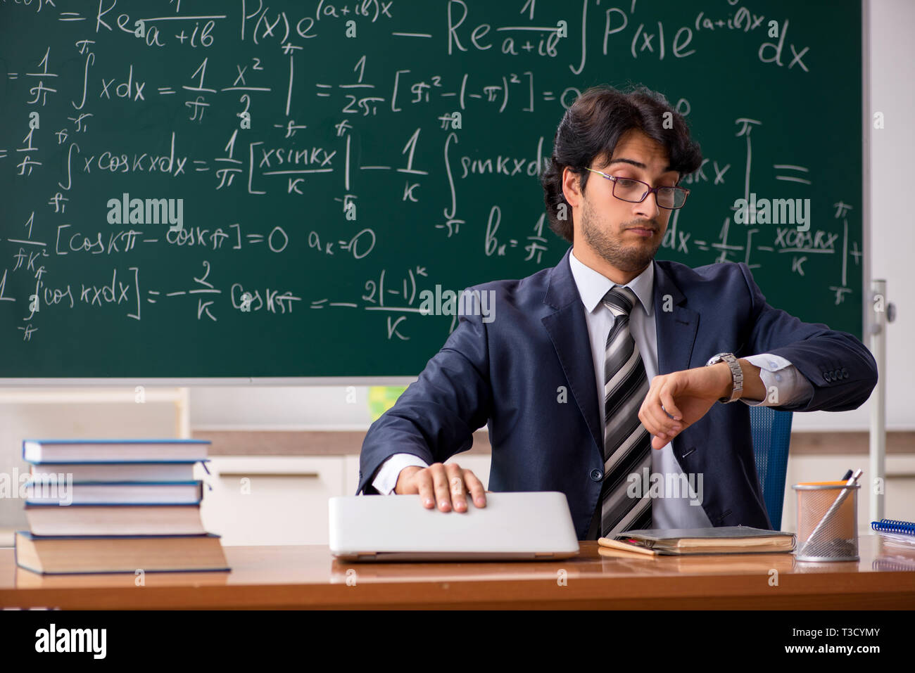 Young male math teacher in classroom Stock Photo - Alamy