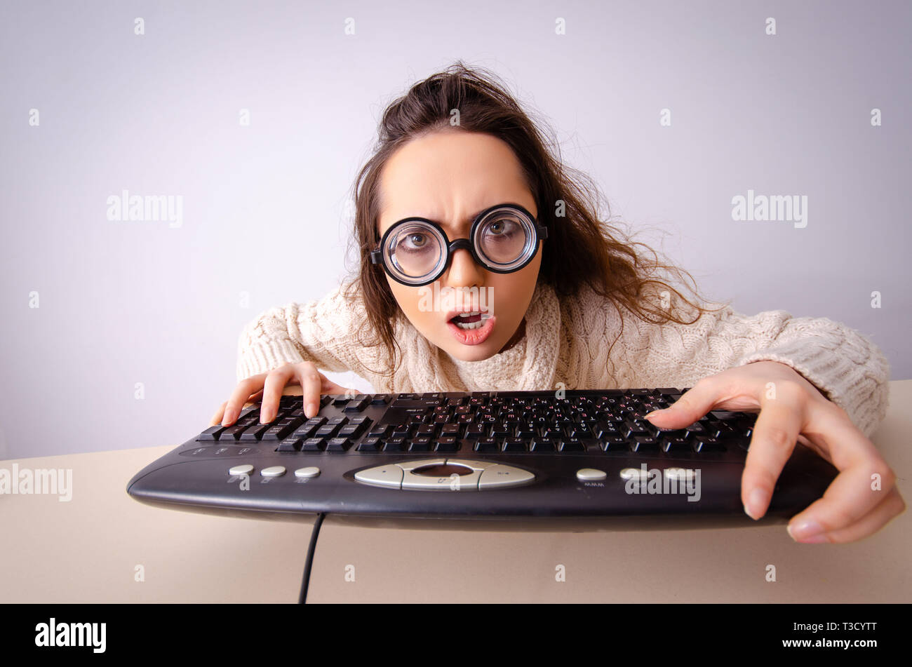 Funny nerd girl working on computer Stock Photo - Alamy
