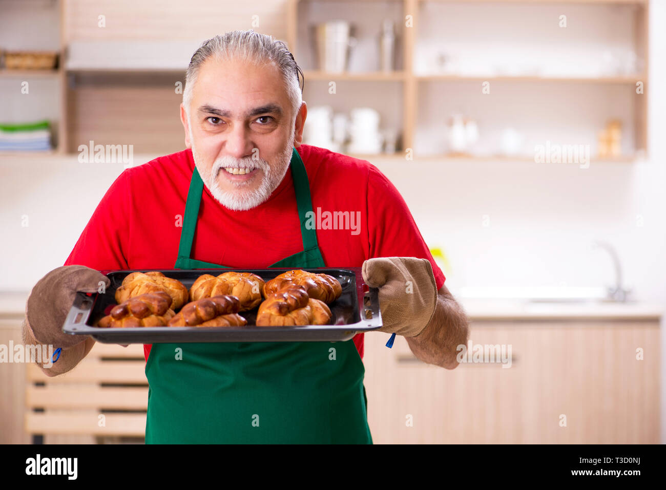 Old male baker working in the kitchen Stock Photo - Alamy