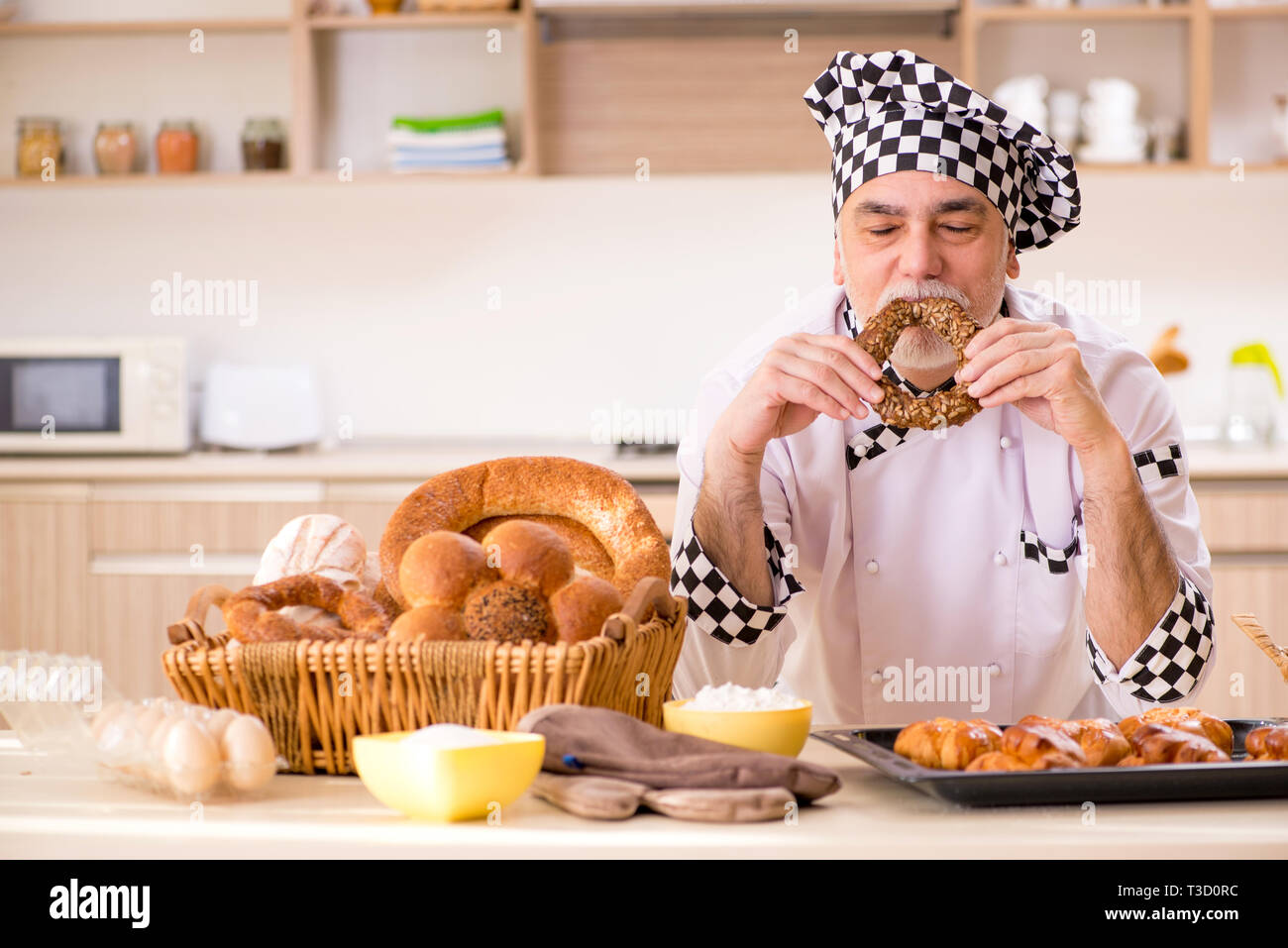 Old male baker working in the kitchen Stock Photo - Alamy