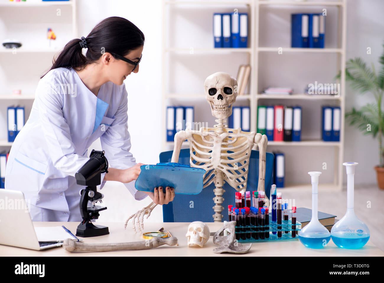 Young female archaeologist working in the lab Stock Photo - Alamy