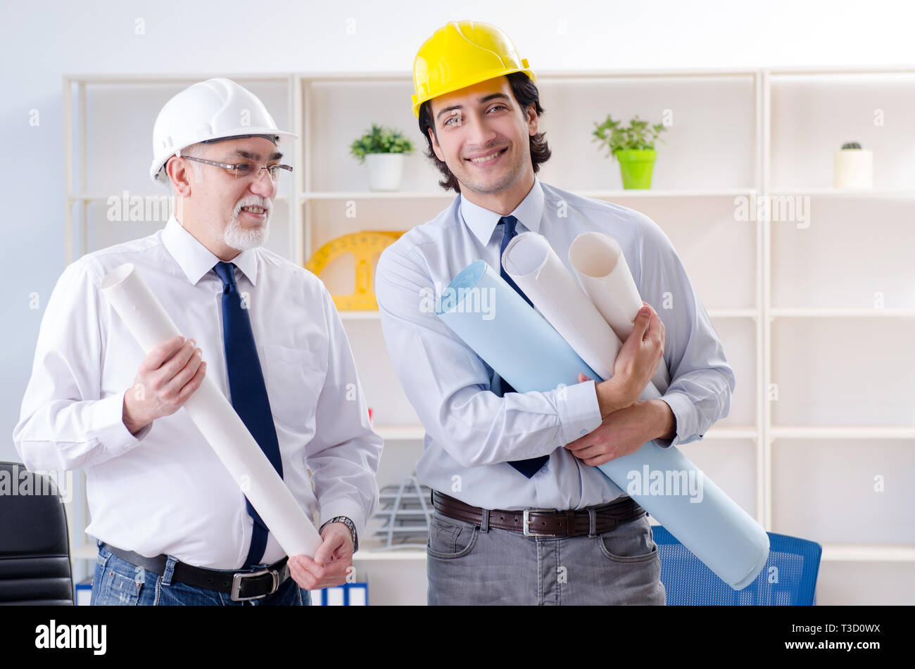 Two engineers colleagues working under project Stock Photo - Alamy