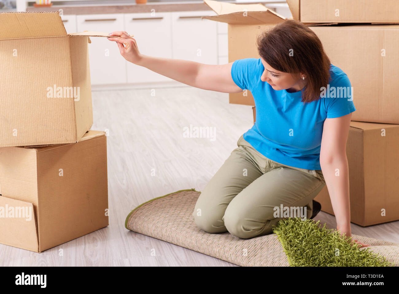 Middle-aged woman moving to new flat Stock Photo - Alamy