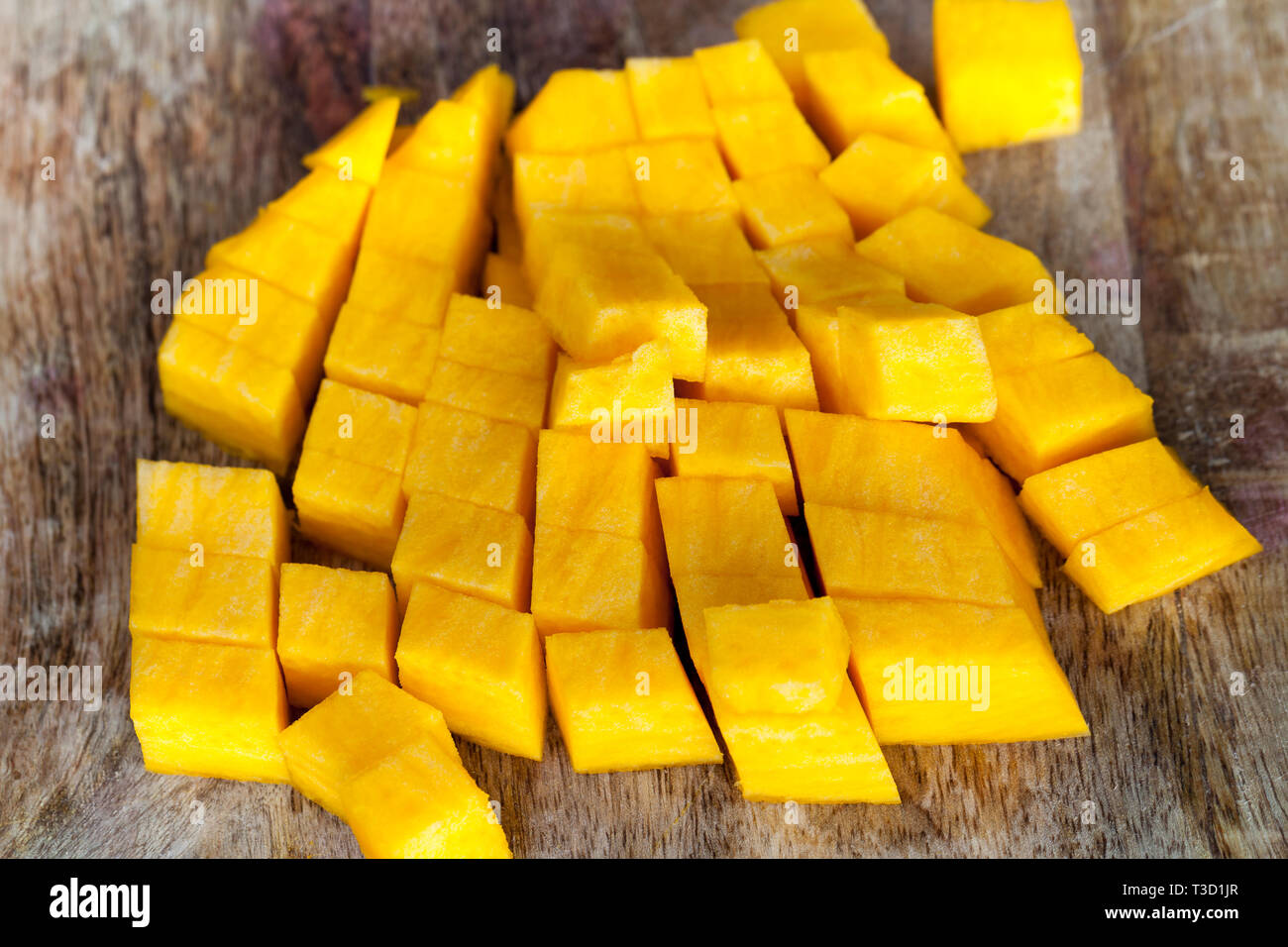 Cut into cubic pieces of ripe yellow pumpkin pulp while cooking in the ...