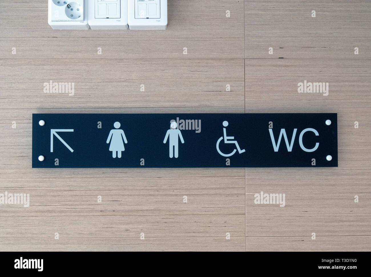 Toilet sign and direction on wall Stock Photo - Alamy