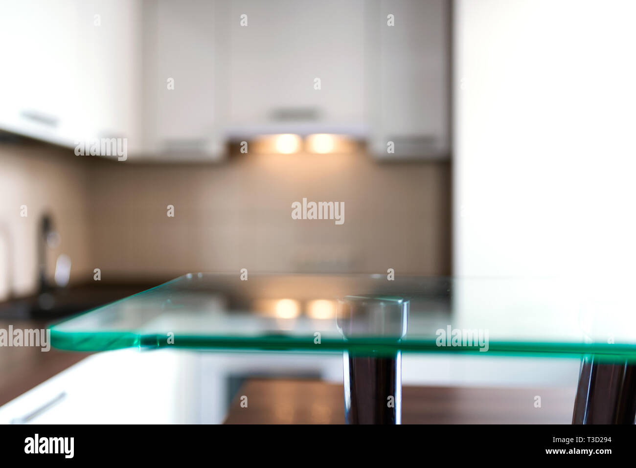 Blurred modern kitchen background with glass stand Stock Photo - Alamy