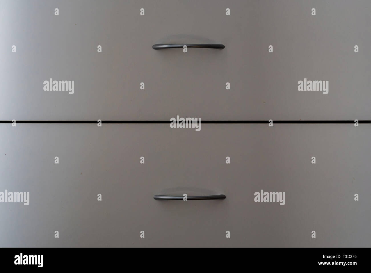 Two closed sliding wooden drawers with metal handles Stock Photo - Alamy