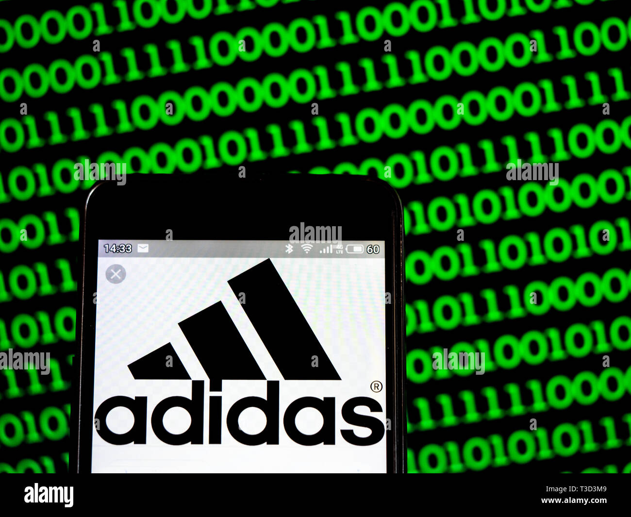 In this photo illustration an Adidas AG logo seen displayed on a smart ...