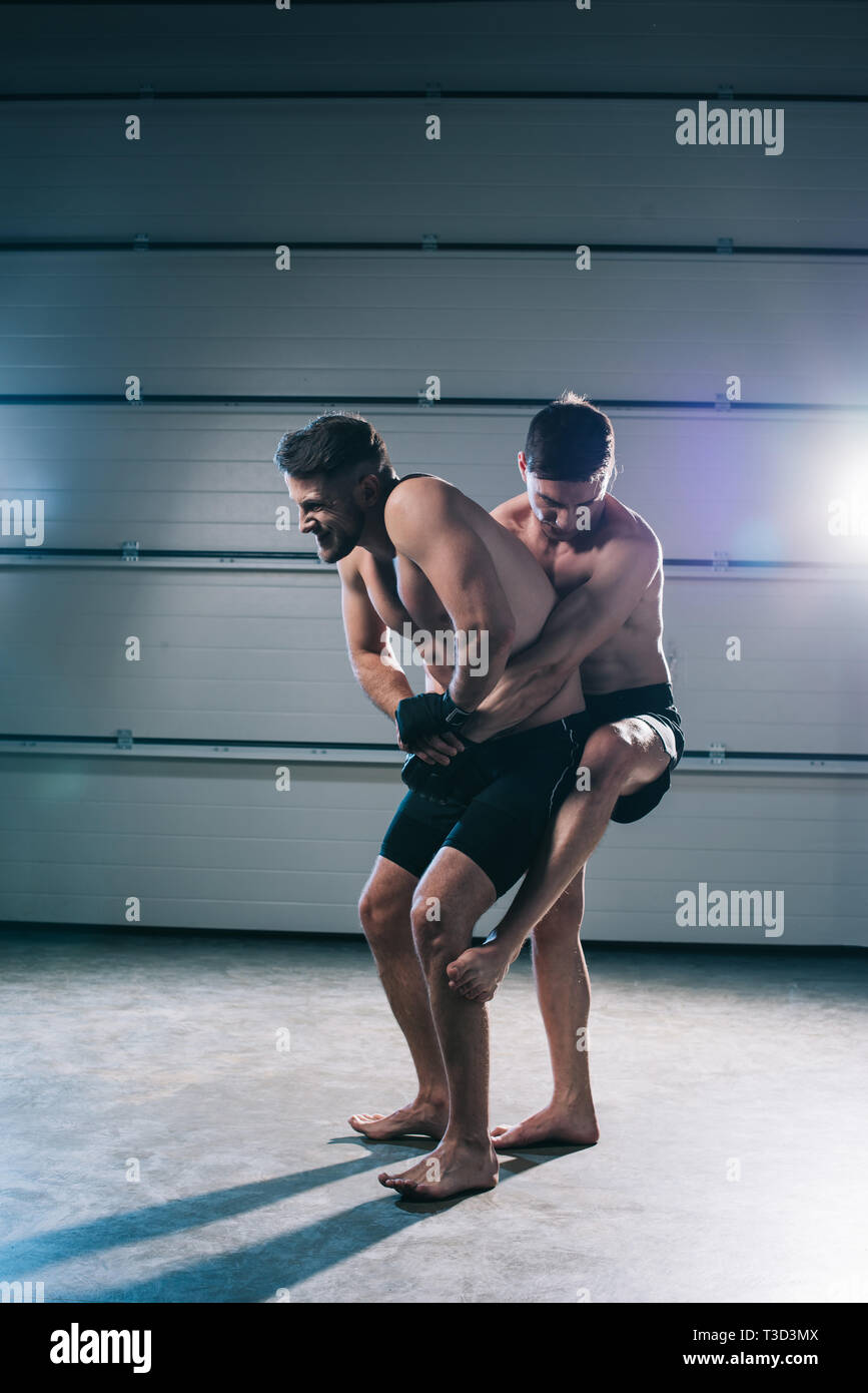 muscular mma fighter clinching sportive shirtless opponent Stock Photo ...