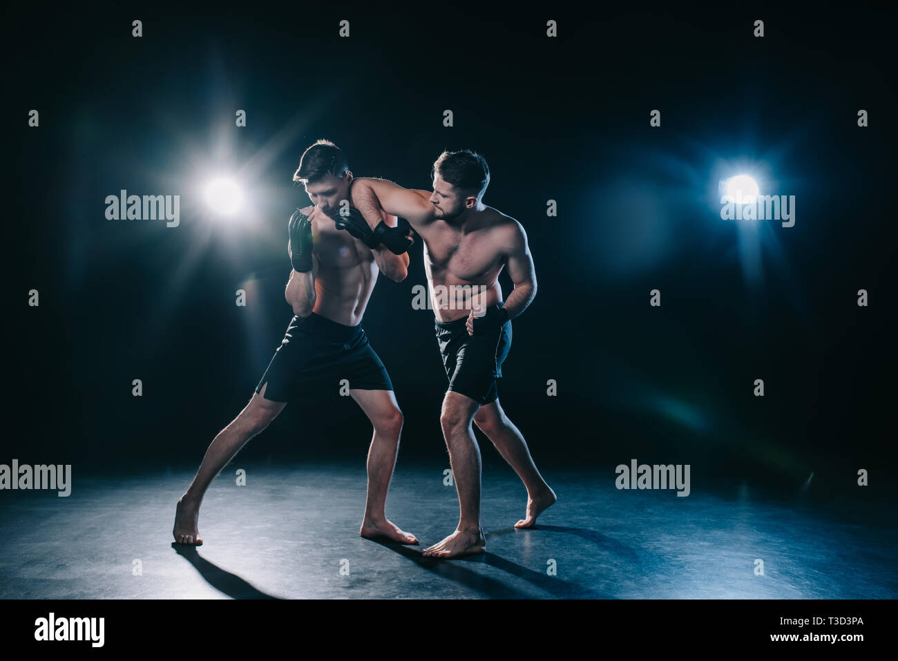 mma fighter punching another sportsman during muay thai training Stock ...