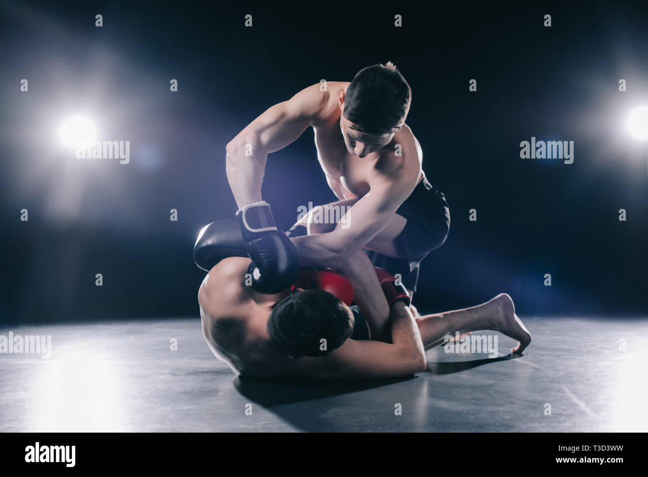 shirtless muscular strong mma fighter in boxing gloves clinching ...