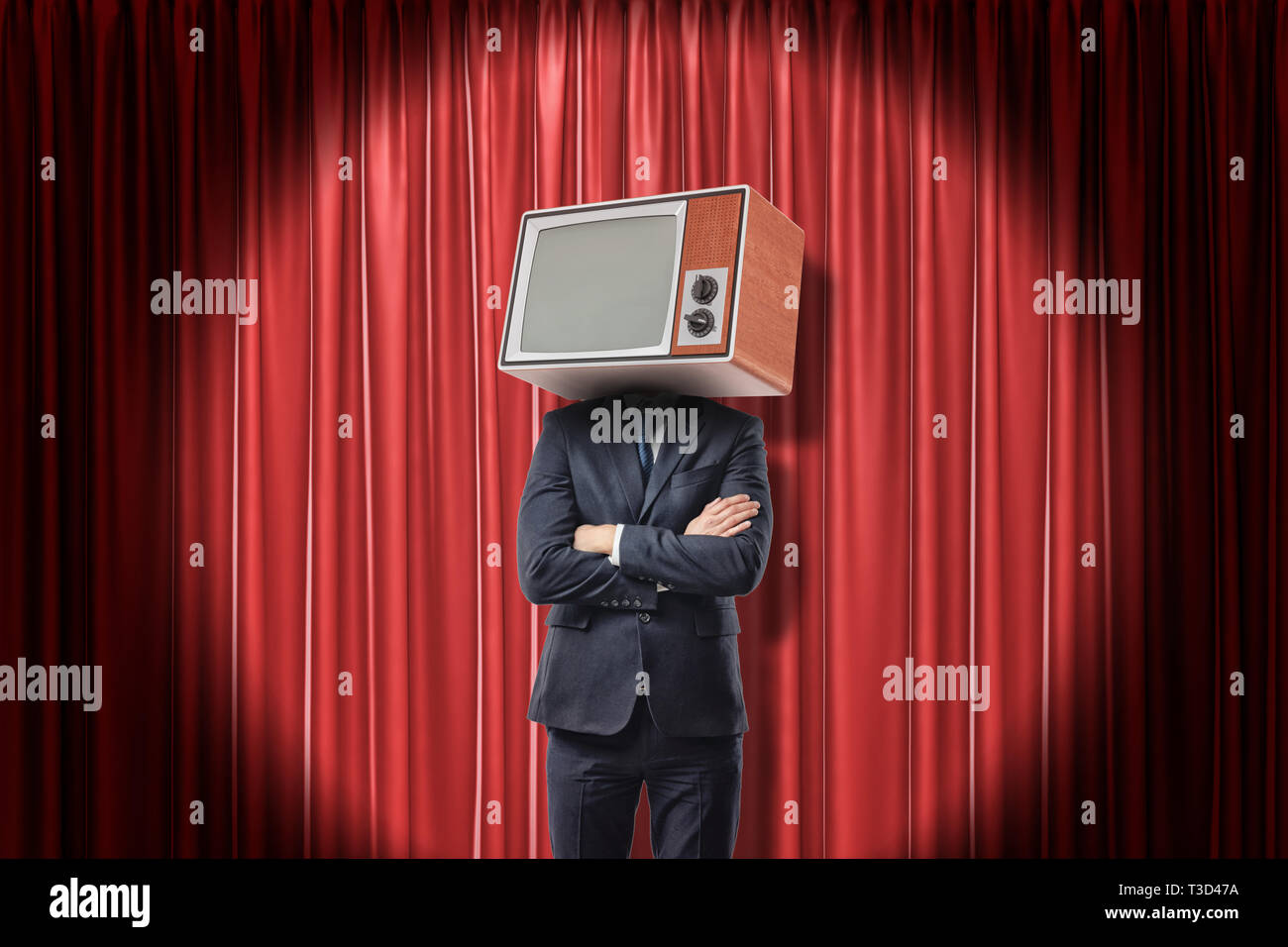 Man in suit standing with arms folded, with TV set instead head, in ...