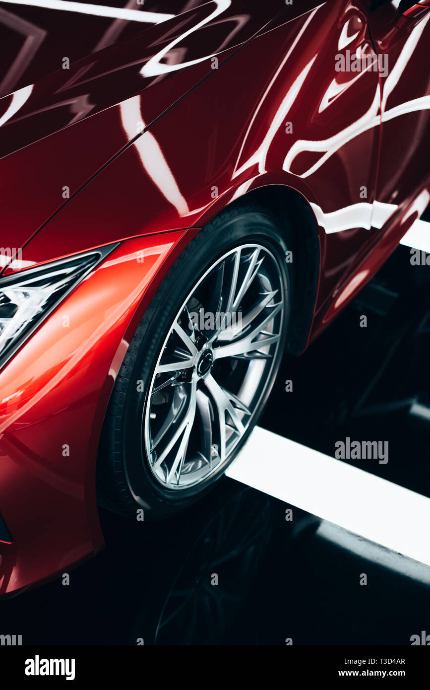 new shiny red automobile with metallic wheel in car showroom Stock ...