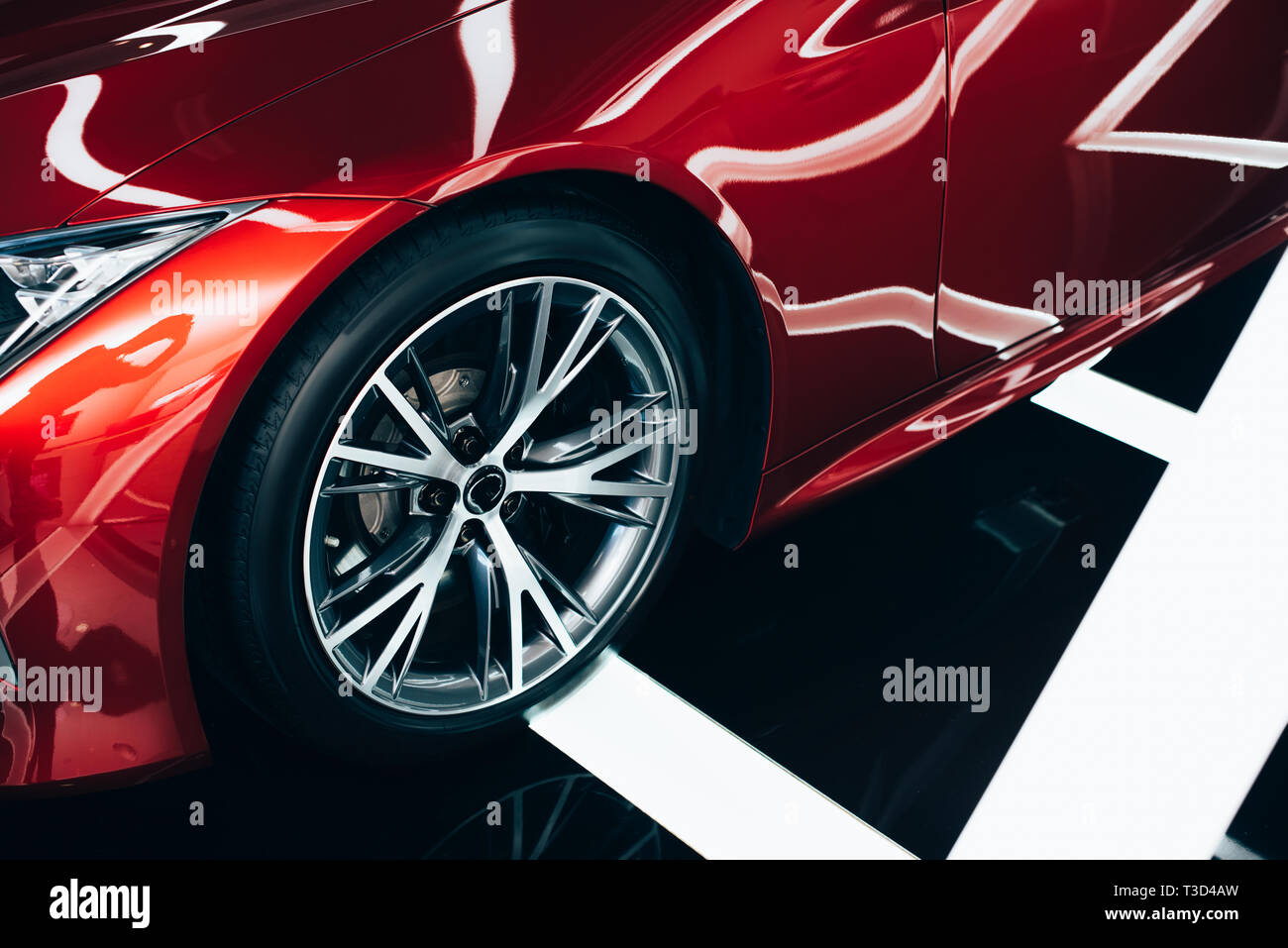 shiny new red automobile with metallic wheel in car showroom Stock ...
