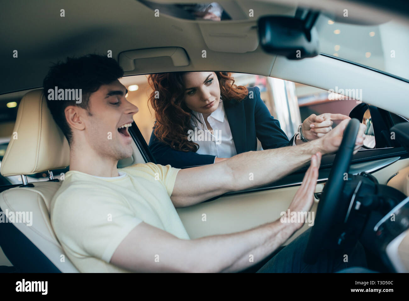 selective focus of excited man sitting in new car near car dealer Stock ...