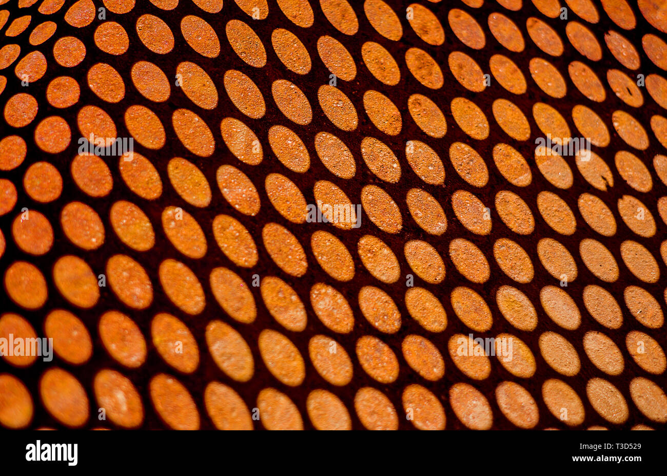 Closeup shadow from perforated net on rusty metal sheet. Texture of big ...
