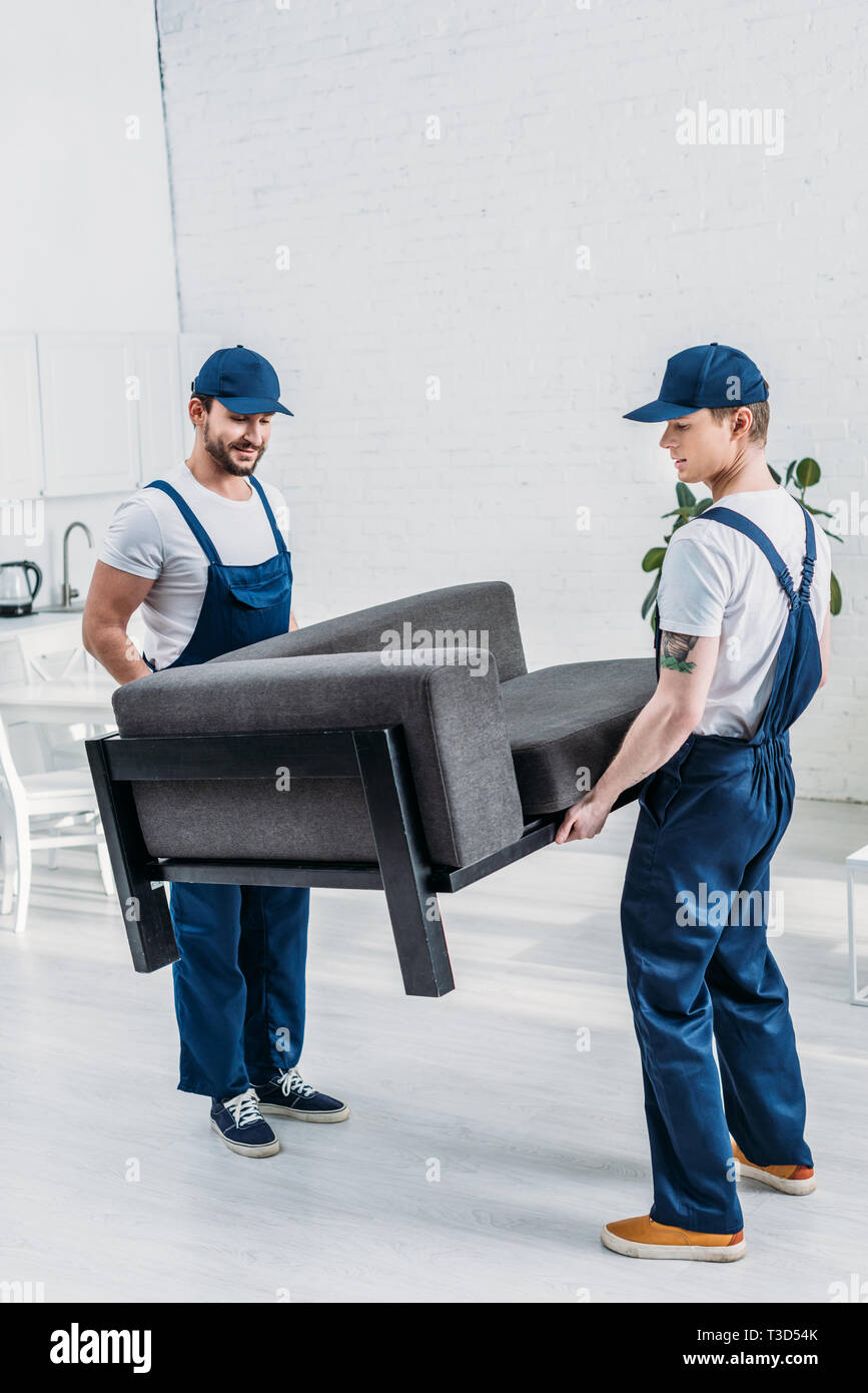 Two men carrying furniture hi-res stock photography and images - Alamy