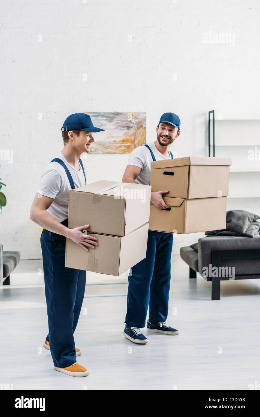 Two couriers carrying boxes hi-res stock photography and images - Alamy