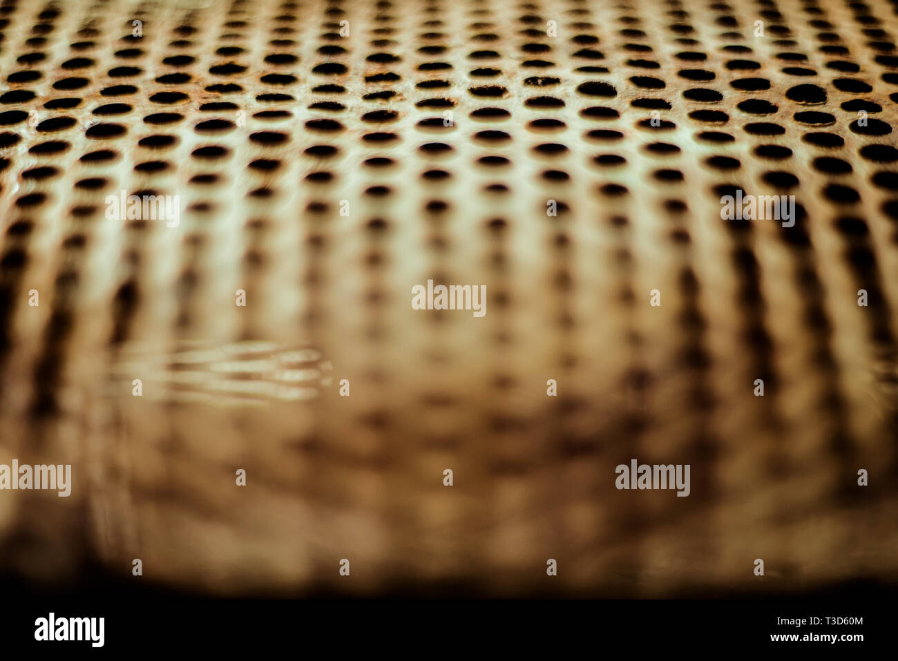 Perforated rusty iron sheet texture. Surface of industrial mesh with ...