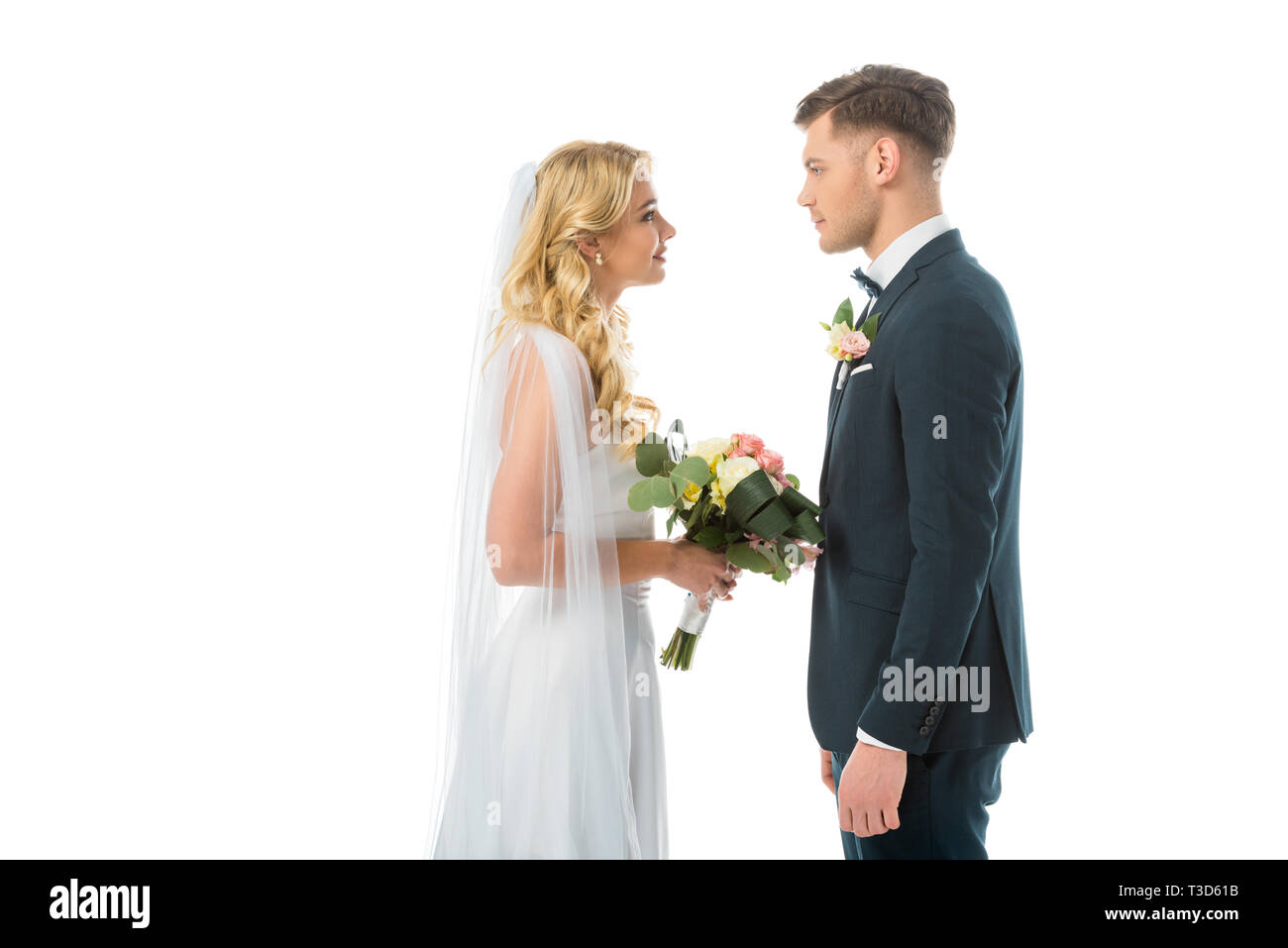 happy bride and smiling groom looking at each other isolated on white ...
