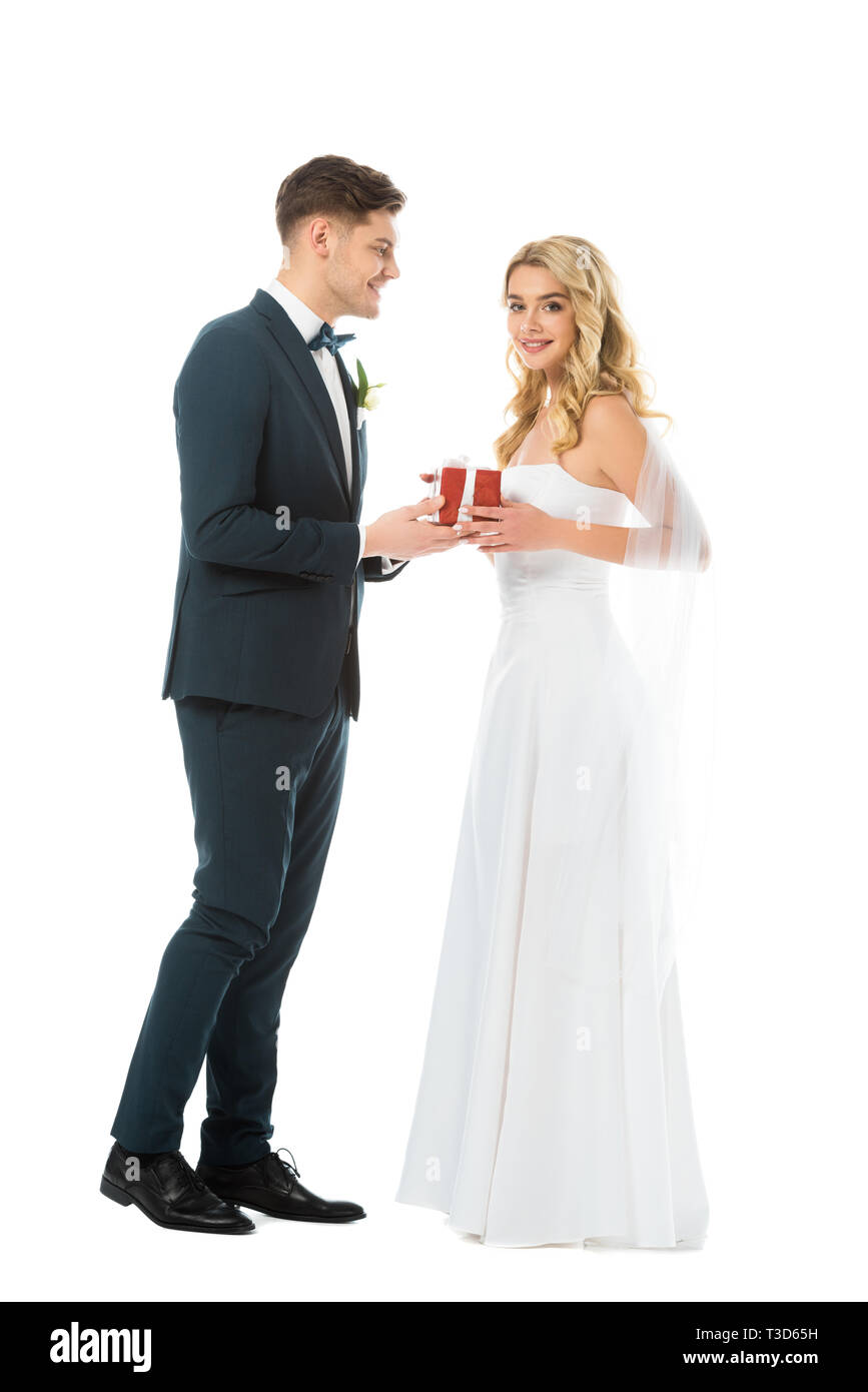 smiling handsome groom presenting gift box to beautiful bride isolated ...