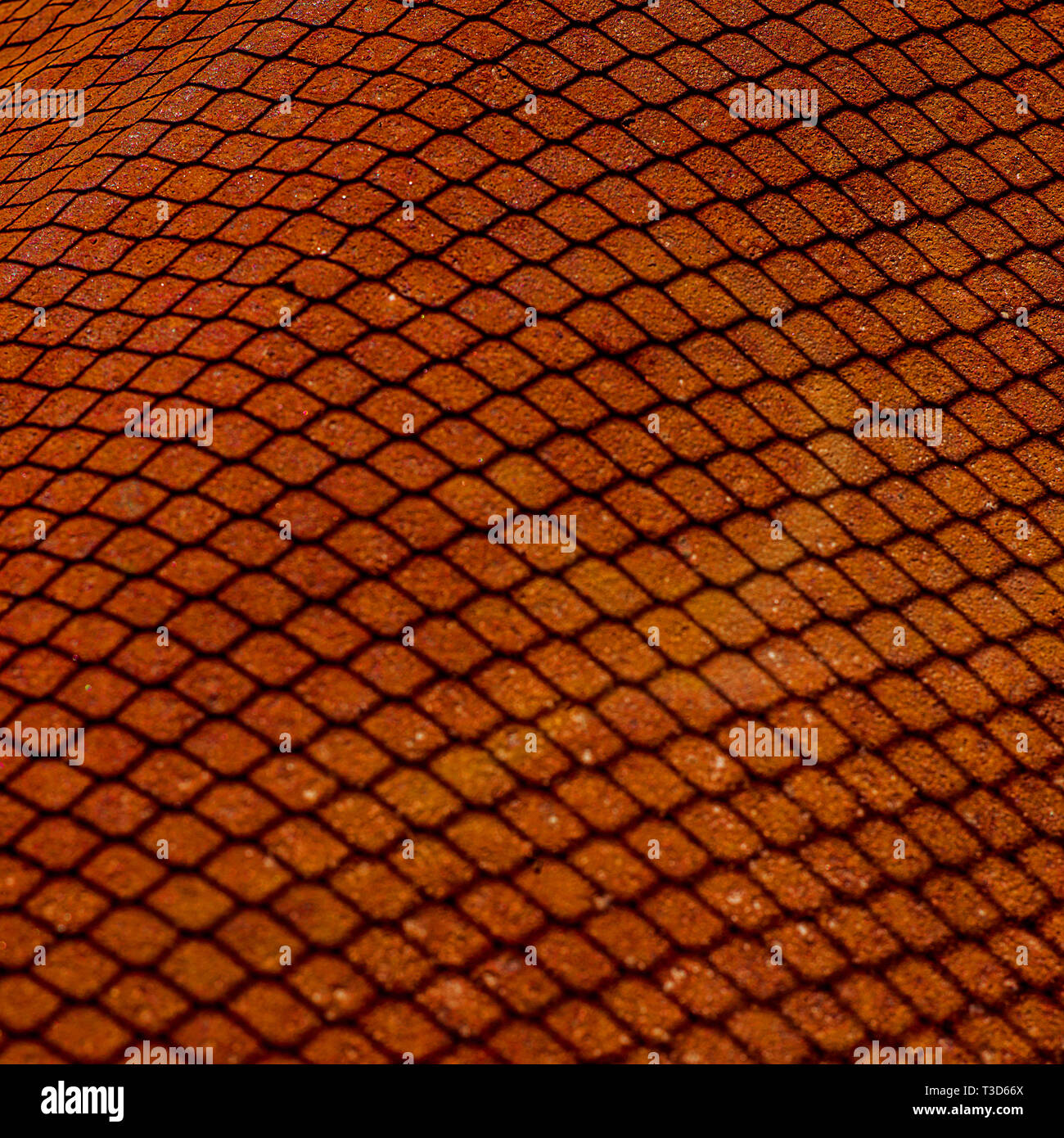 Shedow of weaved wire net on rusty metal sheet. Surface with depth of ...