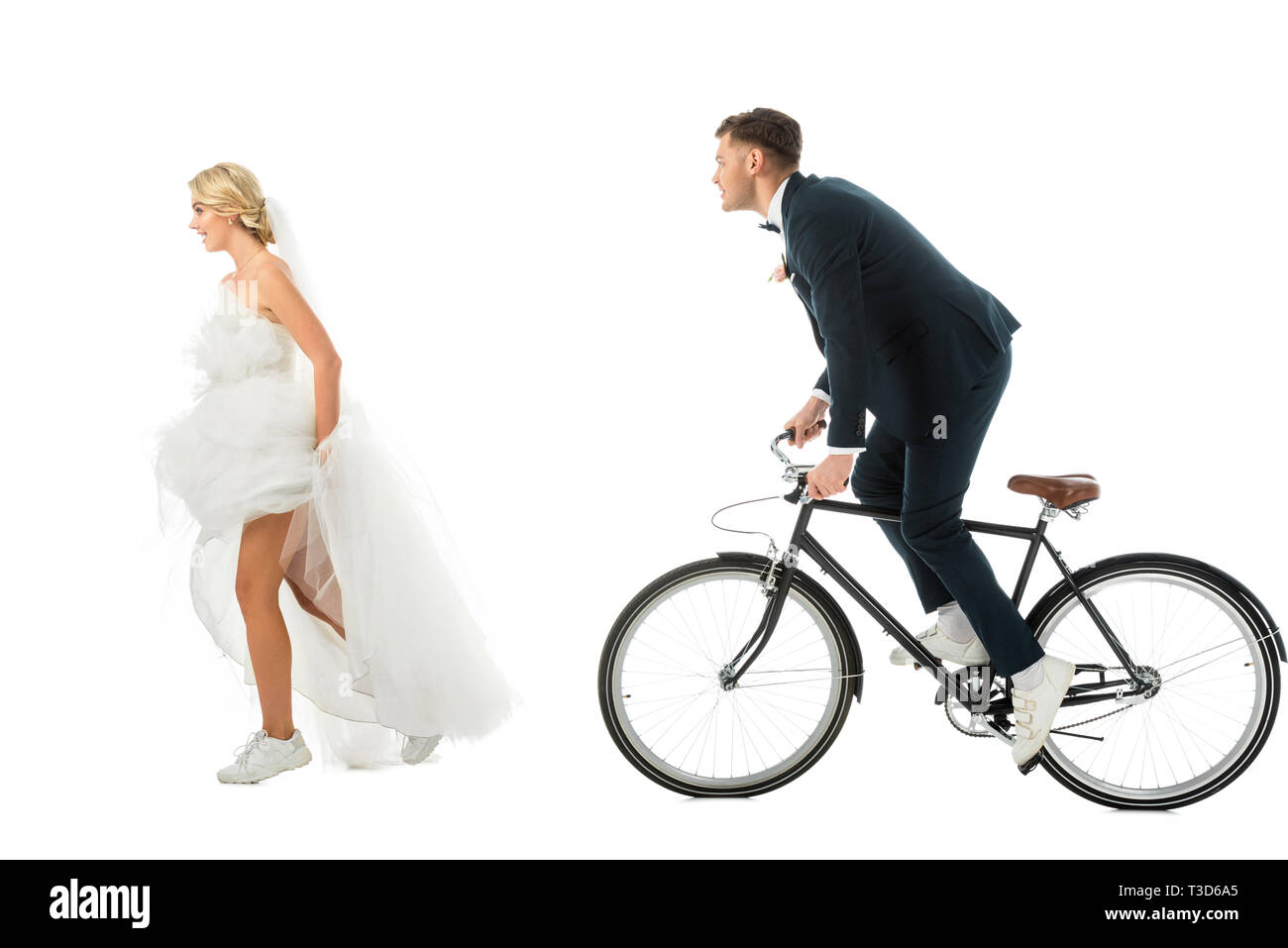 pretty bride in wedding dress running from groom on bicycle isolated on ...
