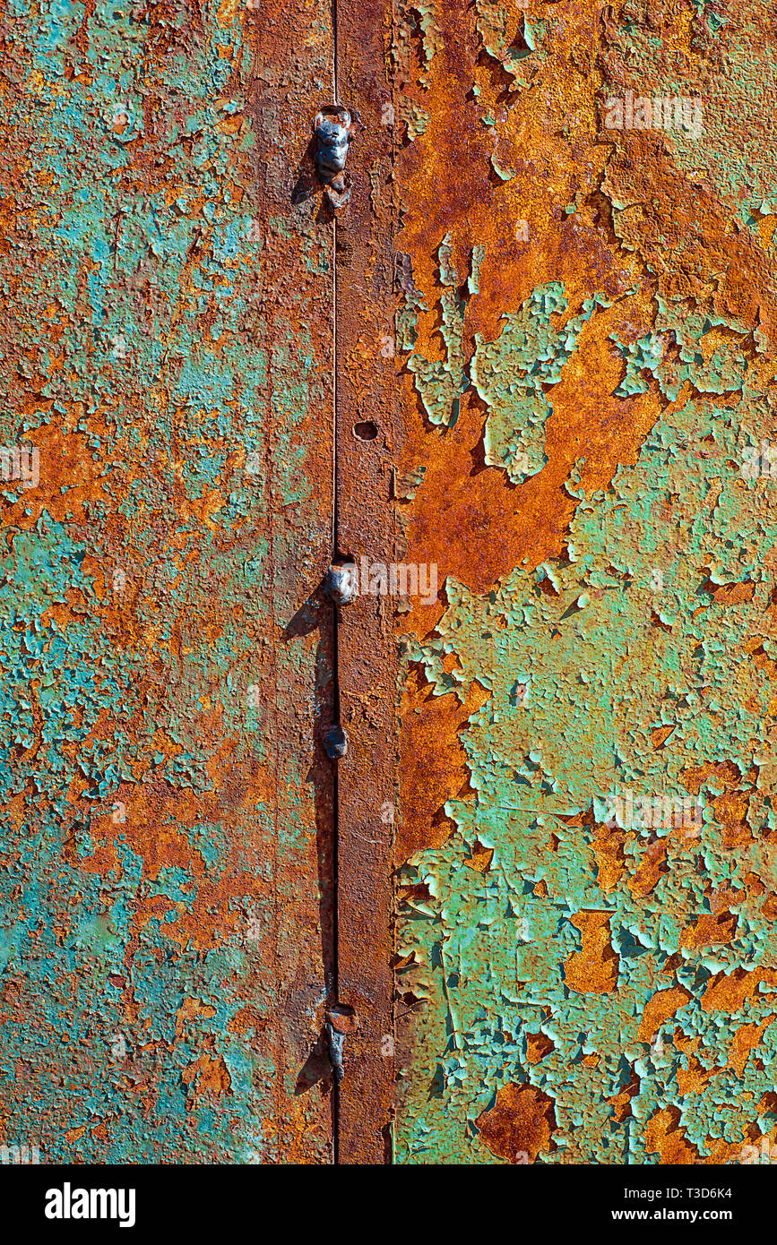 Texture of old rusty metal, painted blue and green which becames orange ...