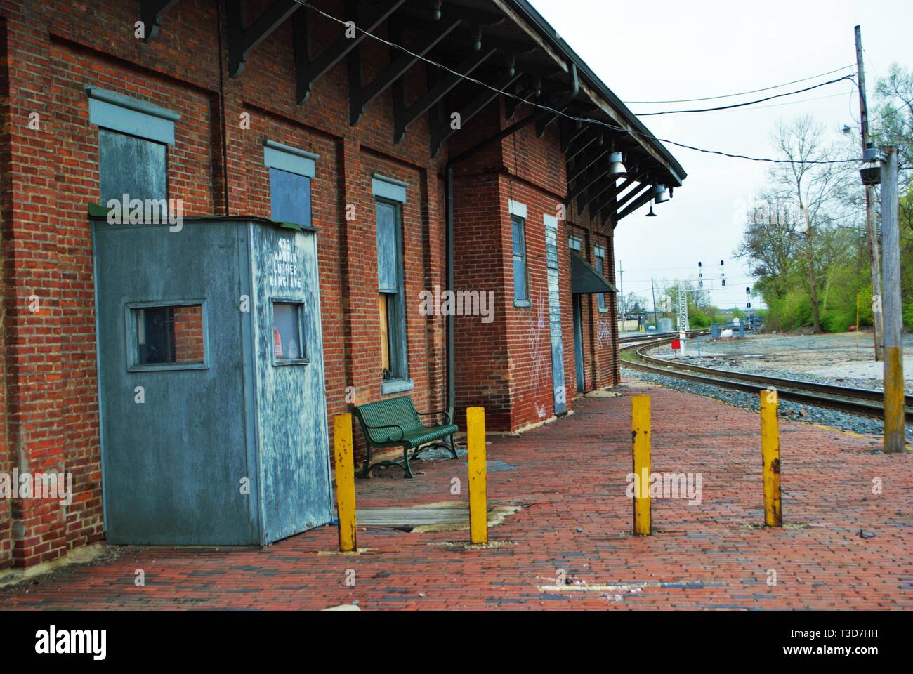 abandoned brick train depot with tracks and graffiti Stock Photo - Alamy