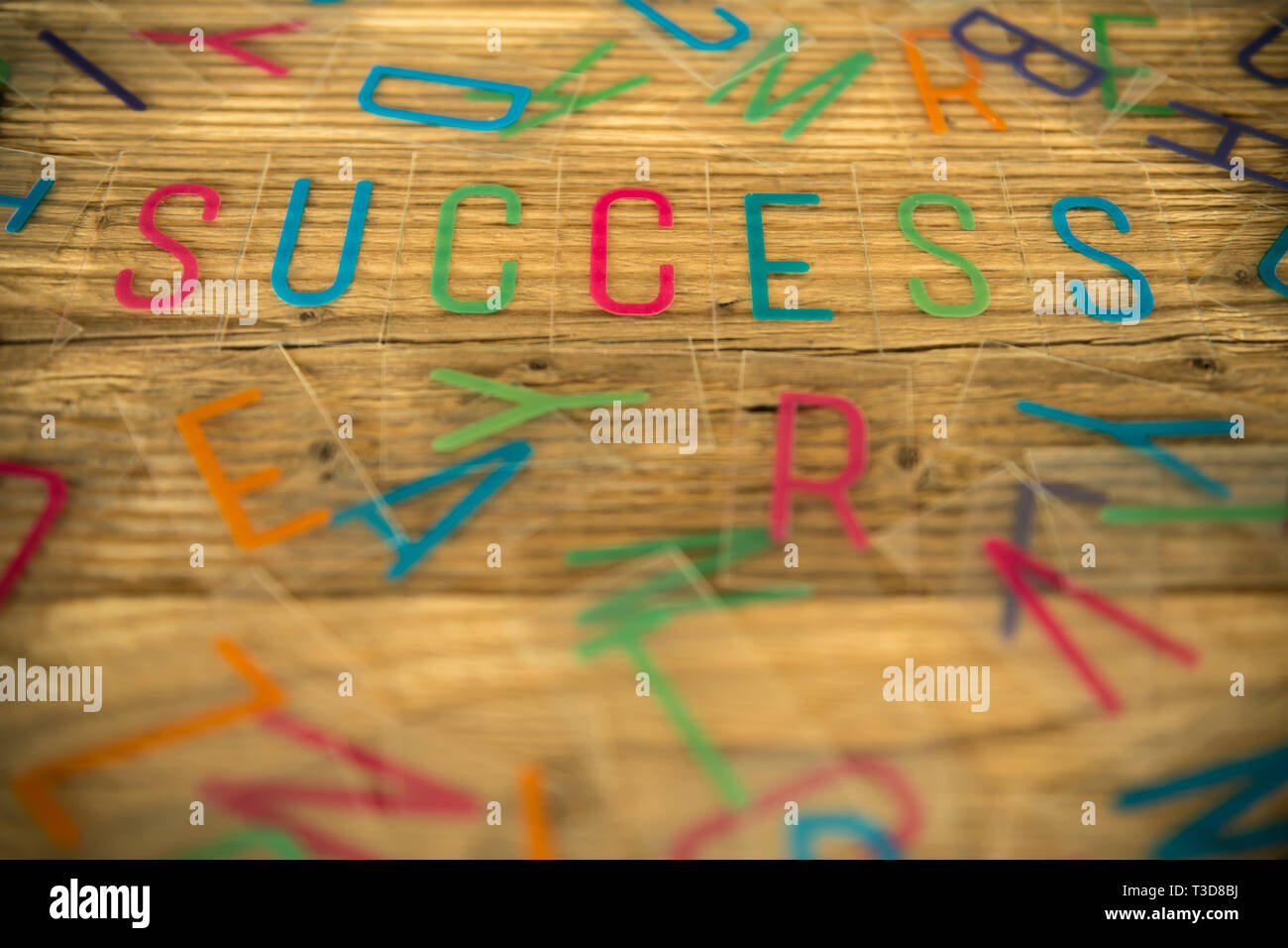 Colored letters on a table. The word success is written Stock Photo - Alamy