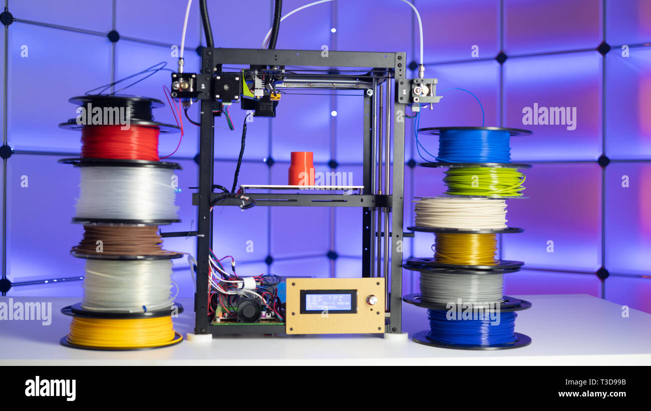 3d printer and plastic filament on color background Stock Photo - Alamy