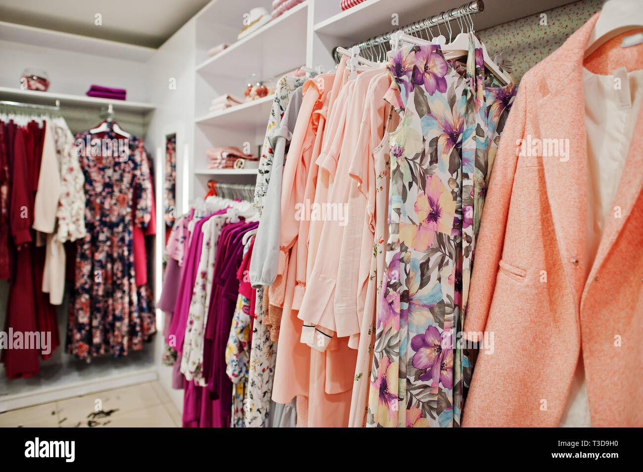 Female peach colorful clothing set of on the racks in clothing store ...