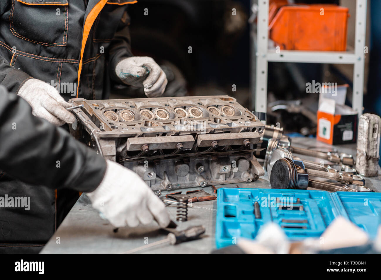 Two mechanics disassembling the engine, overhaul.. Engine on a repair ...