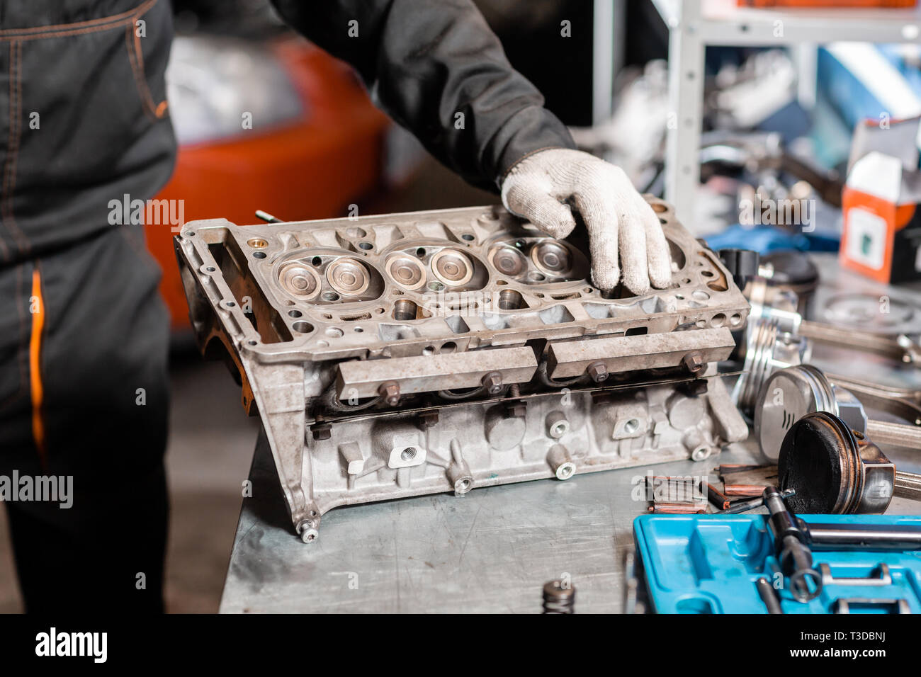Mechanic disassembling the engine, overhaul.. Engine on a repair stand ...