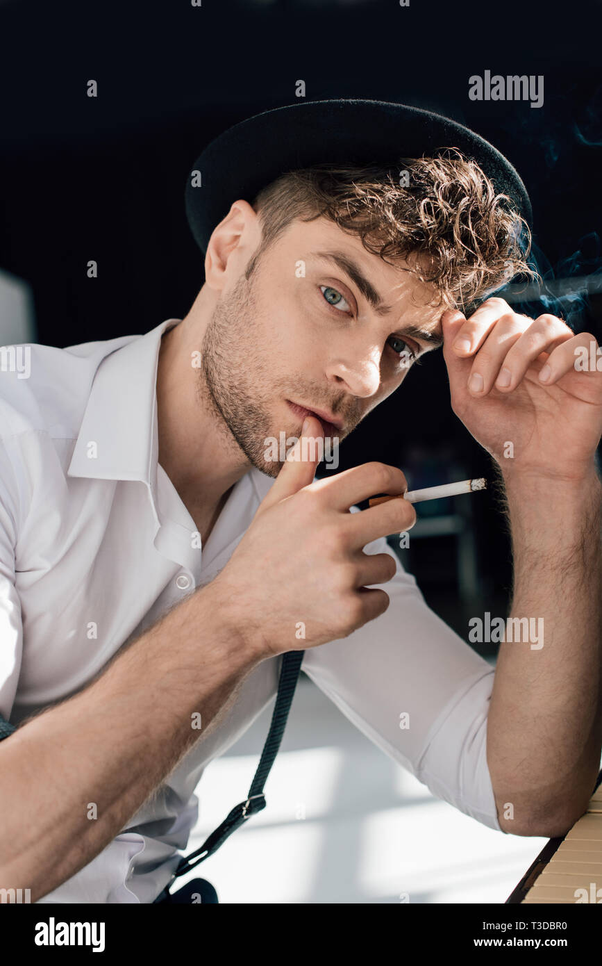 Man smoking in shadows hi-res stock photography and images - Alamy