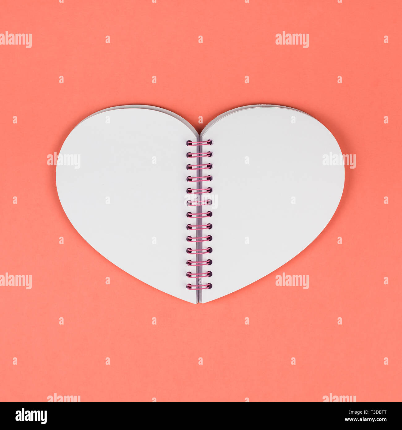 Creative top view flat lay of heart shaped notepad with blank pages as ...