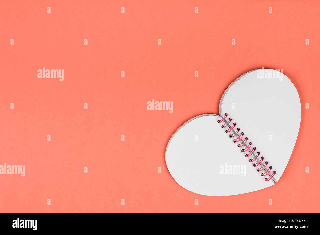 Creative top view flat lay of heart shaped notepad with blank pages as ...