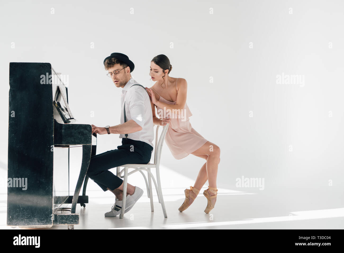 attractive ballerina touching handsome musician playing piano Stock ...