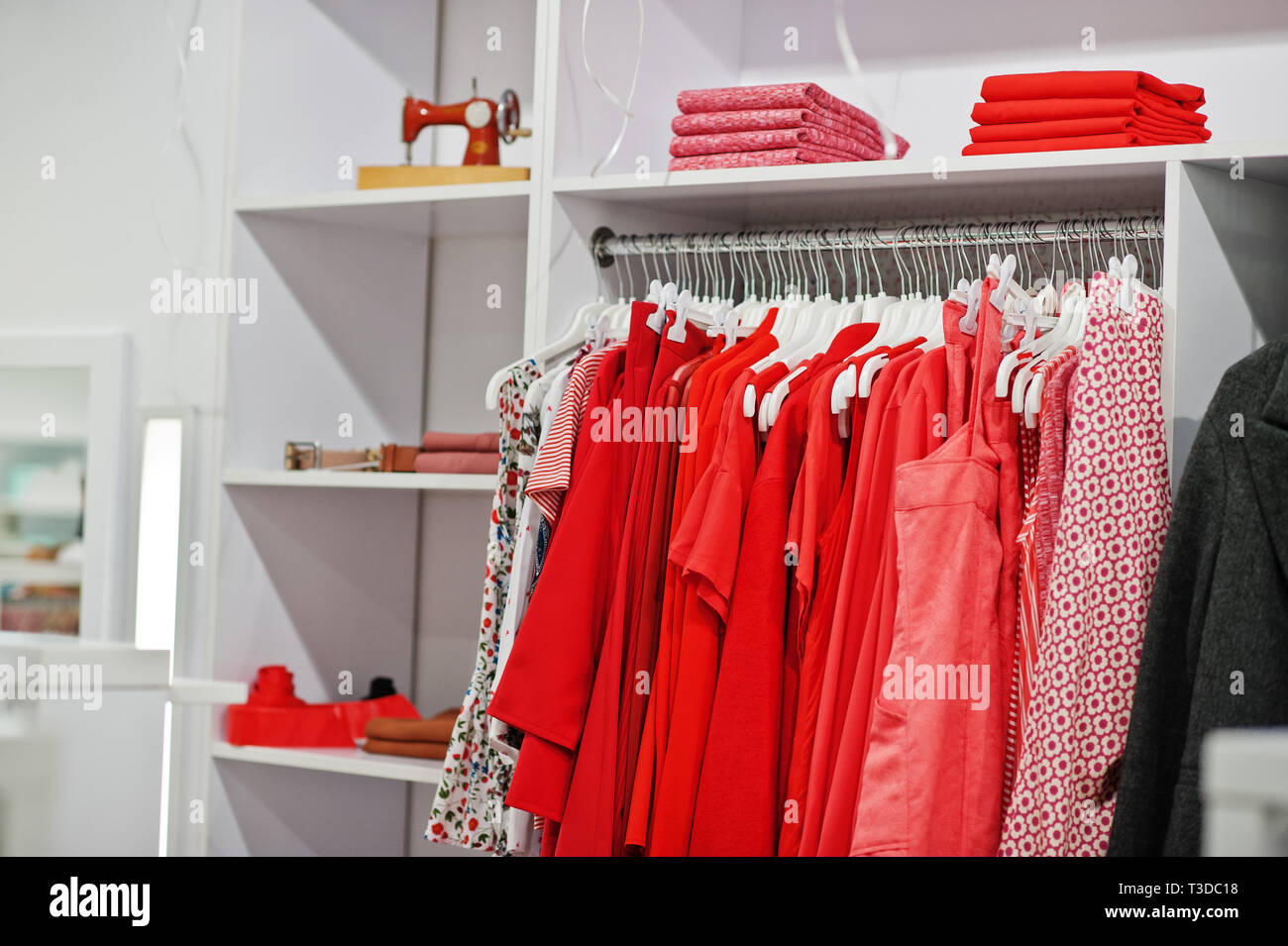 Female red colorful clothing set of on the racks and shelves in ...