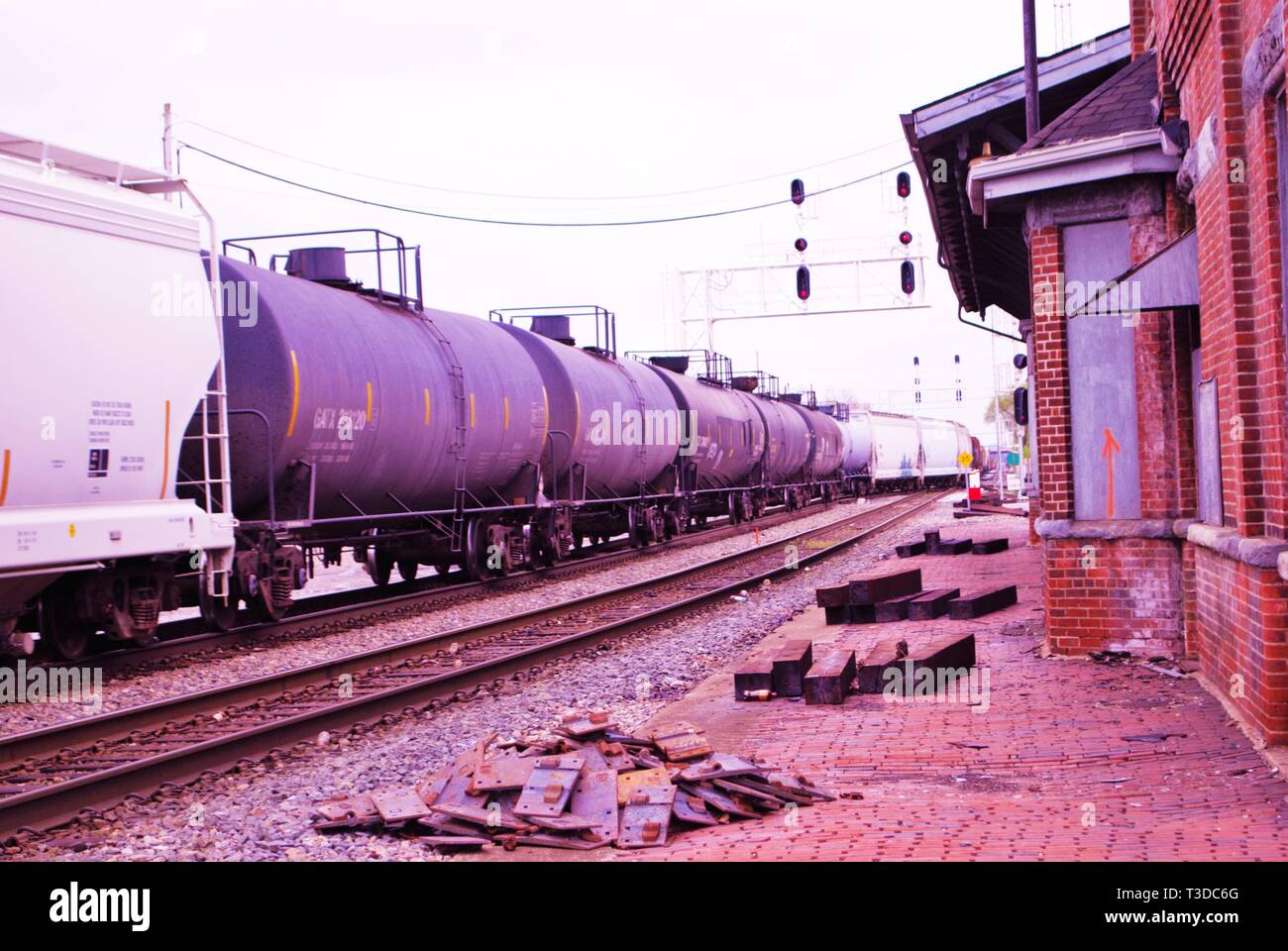 abandoned brick train depot with tracks and graffiti Stock Photo - Alamy