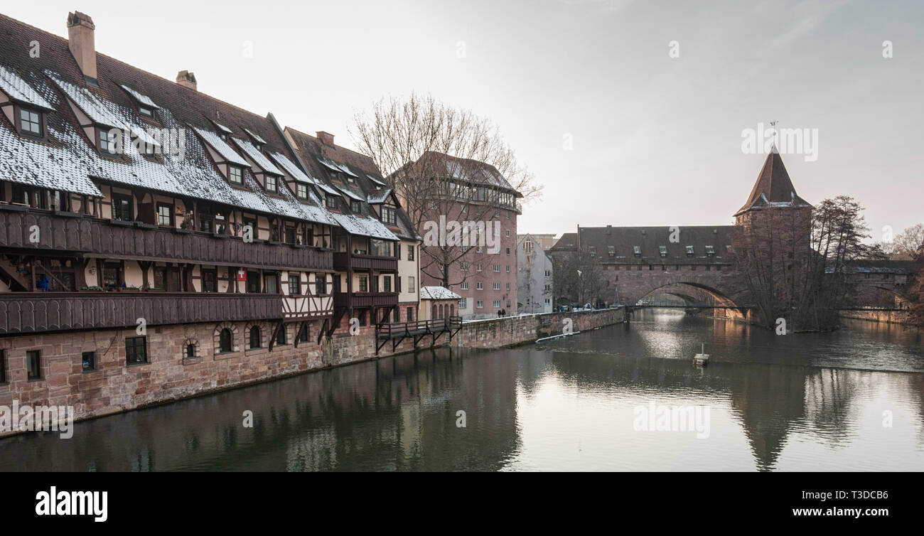 Houses and a bridge reflected in a river in the old town of Nuremberg ...