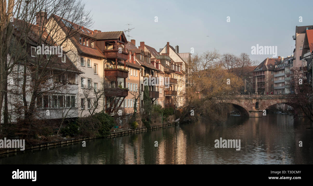 Houses and a bridge reflected in a river in the old town of Nuremberg ...