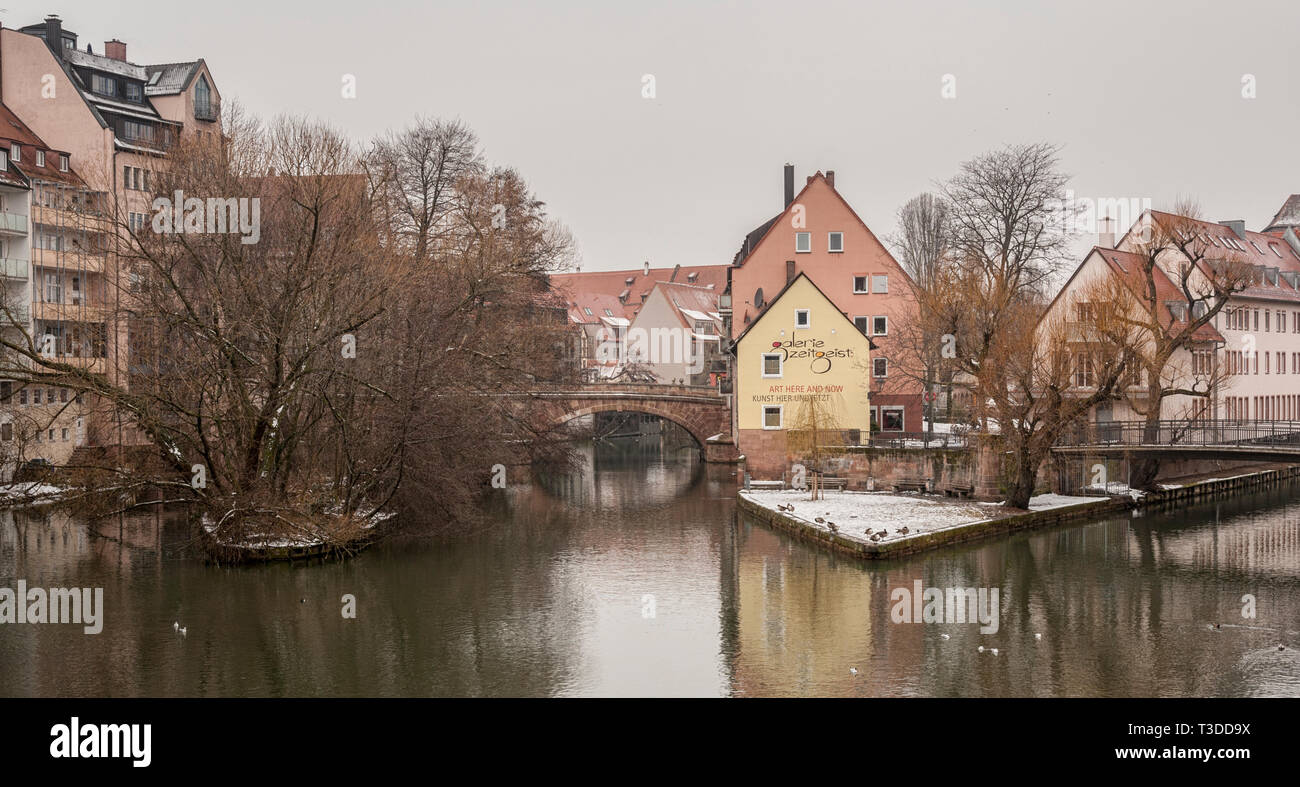 Houses and a bridge reflected in a river in the old town of Nuremberg ...