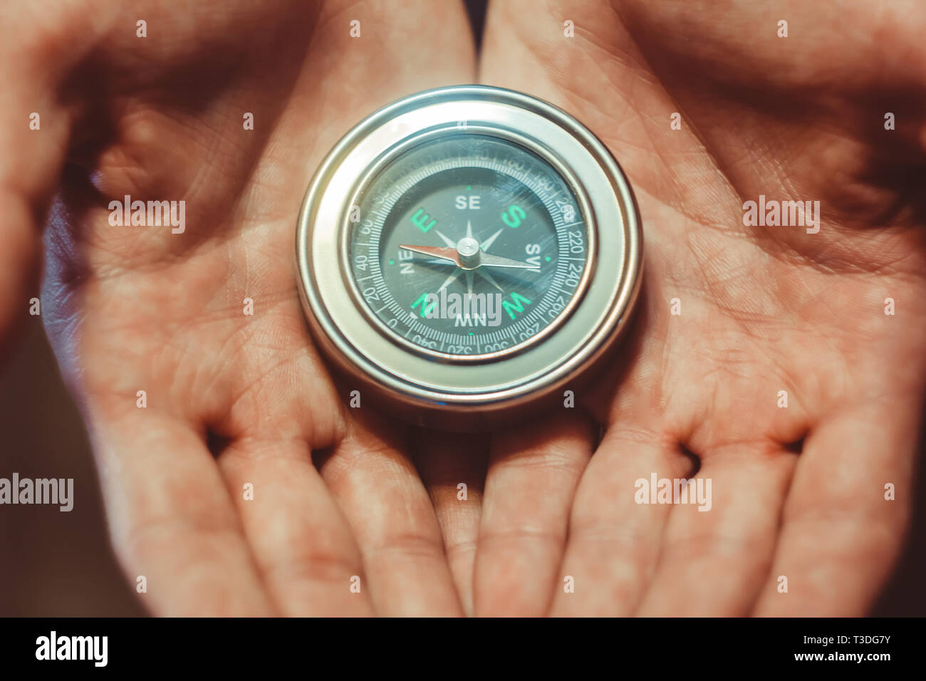 man holding a compass in his hands Stock Photo - Alamy