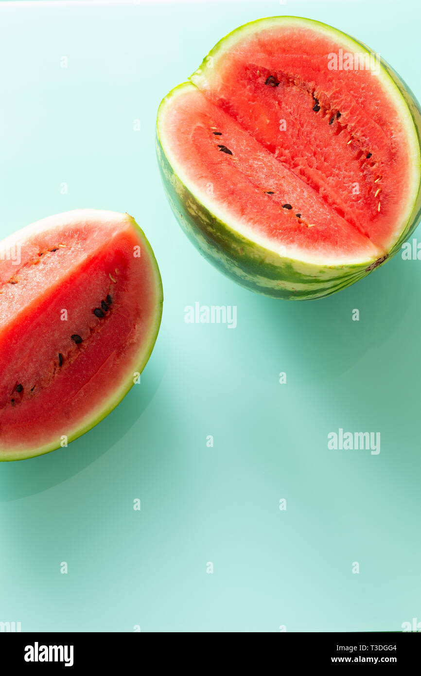 pieces of juicy watermelon on a pastel blue background Stock Photo - Alamy