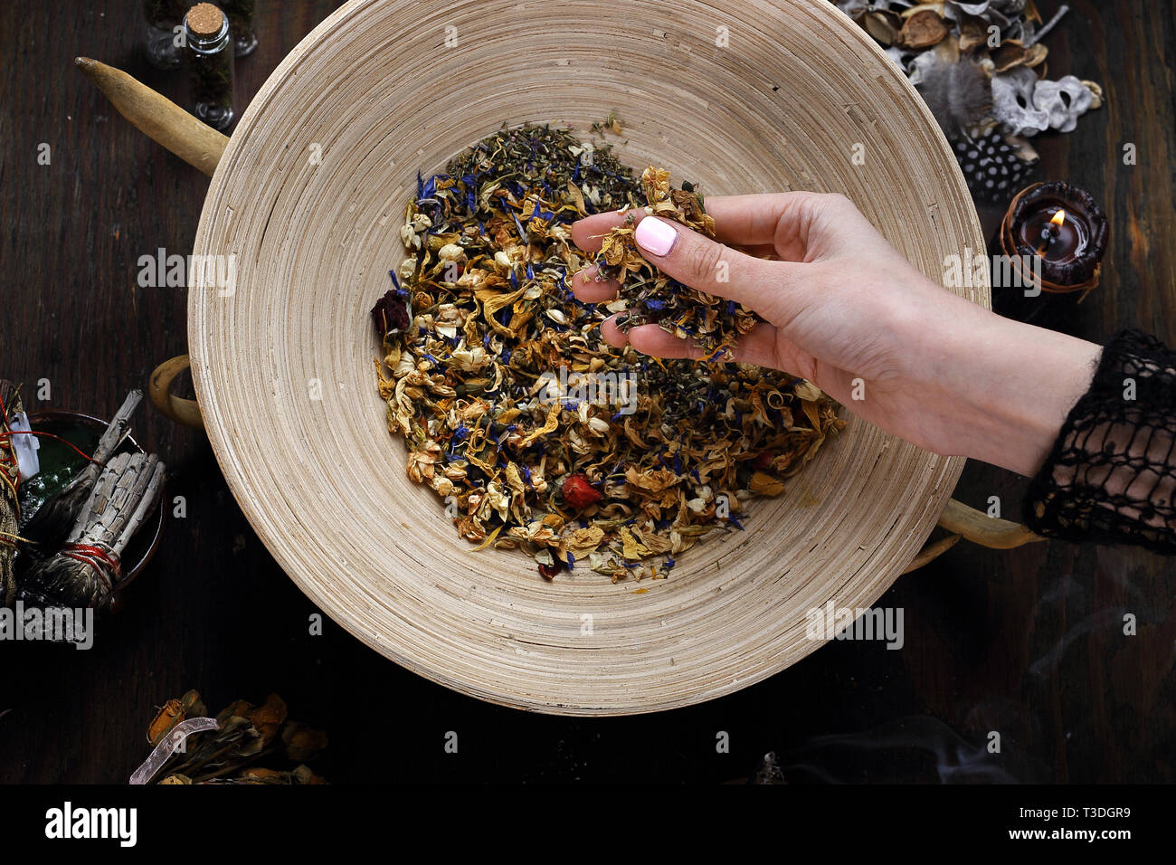 Herbalism, a woman prepares a healing mix of herbs Stock Photo - Alamy