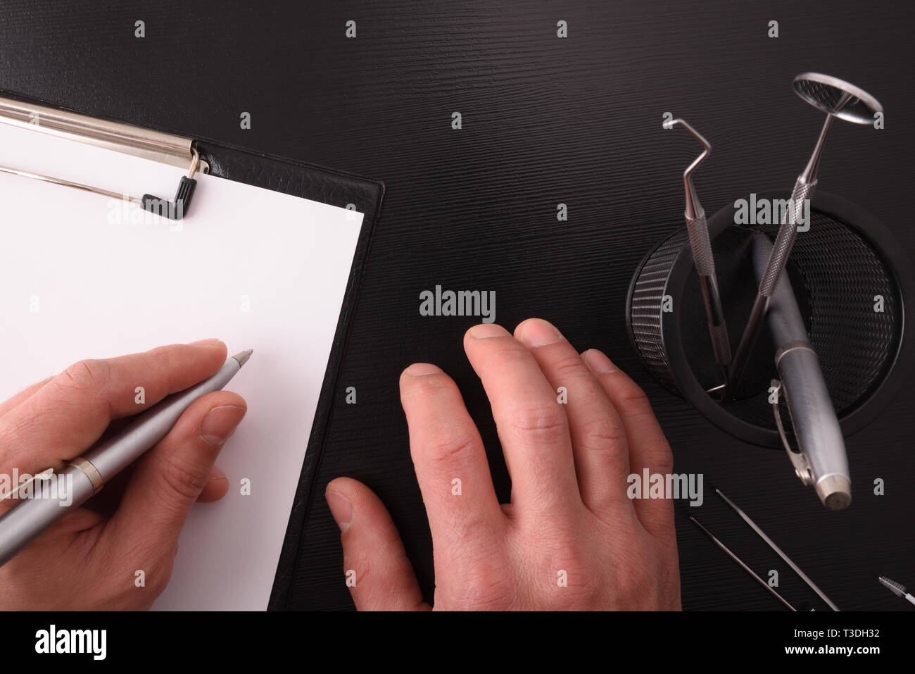 Dentist doctor writing on his desk. Top view. Horizontal composition ...
