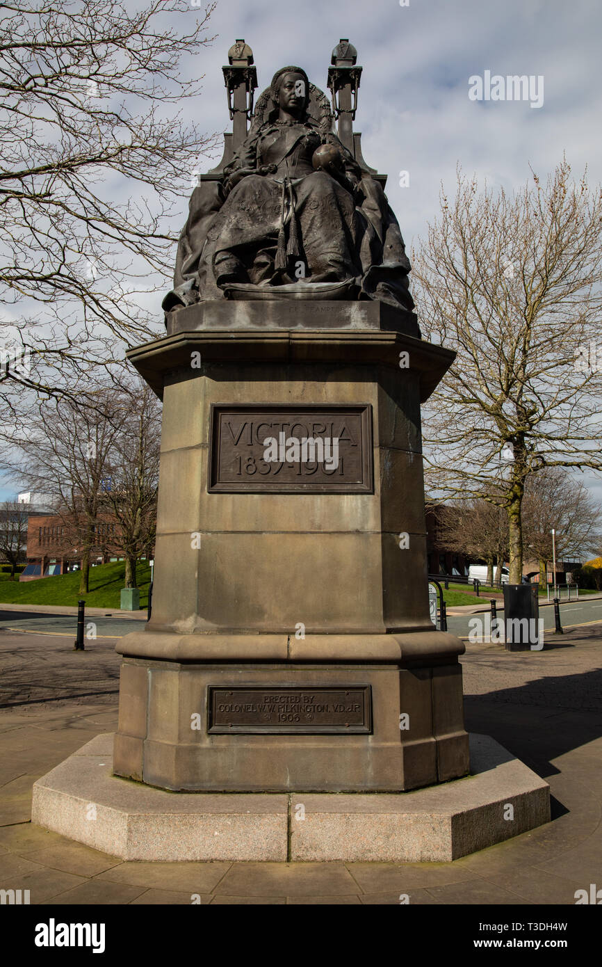 Statue of Queen Victoria on a throne St Helens Merseyside England March ...