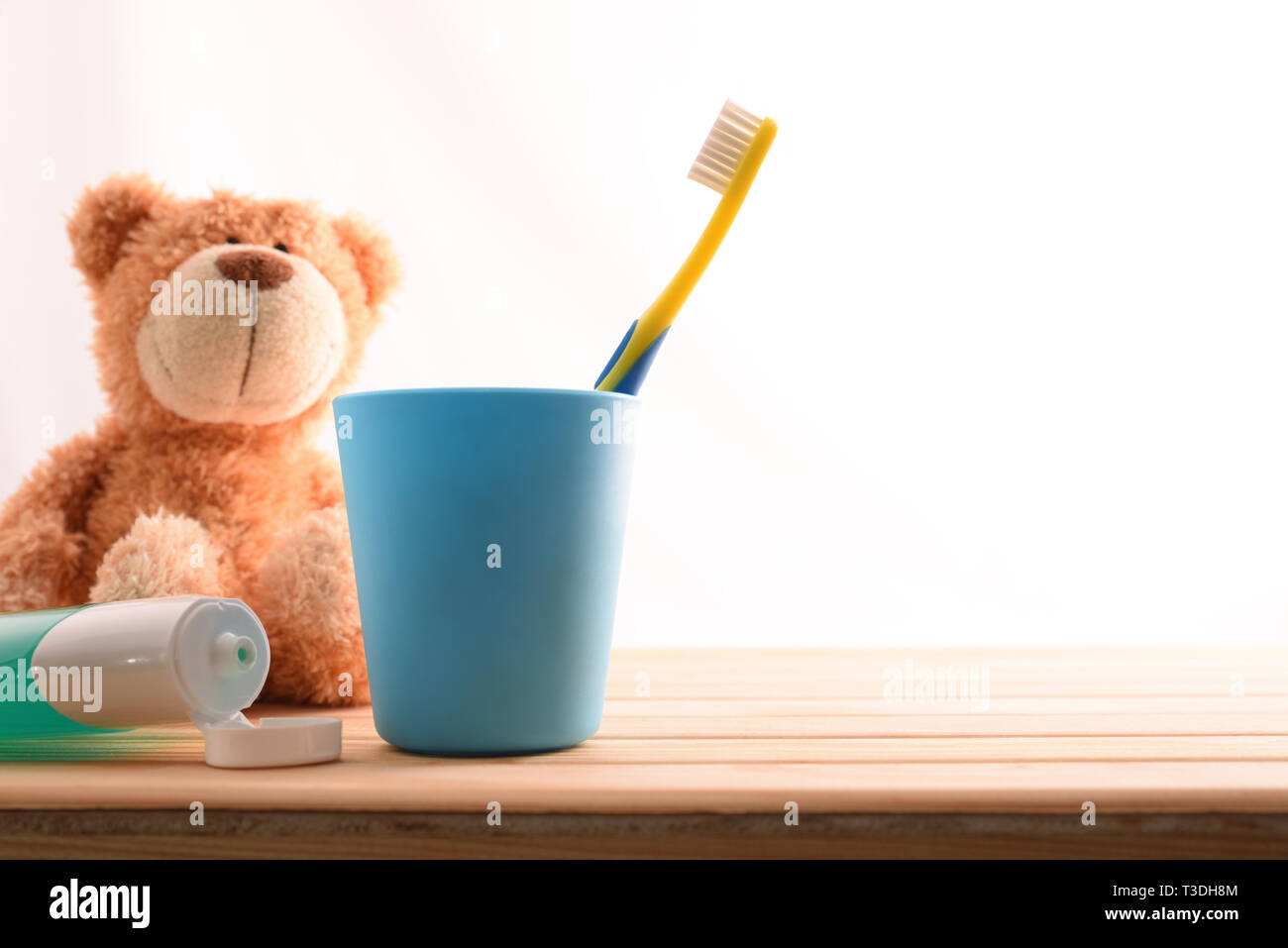 Oral hygiene for children with cleaning elements on wooden table and ...